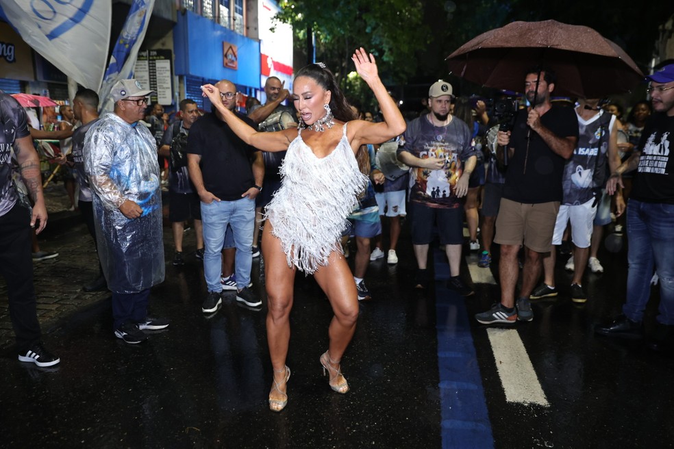 Debaixo de forte chuva, Sabrina Sato samba muito em ensaio de rua da ...