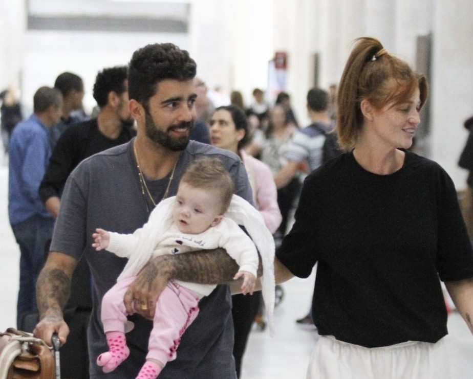 Pedro Scooby recebe Cintia Dicker e a filha, Aurora, em aeroporto no Rio