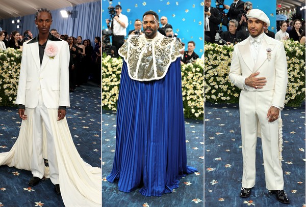 Stevie Wonder tem ajuda de três assistentes para segurar cauda de capa ...